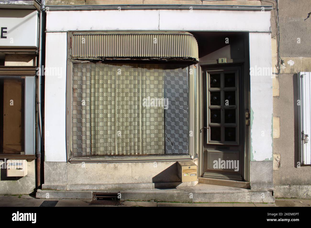 Retro view of an old french shop window with patterned glass here ...
