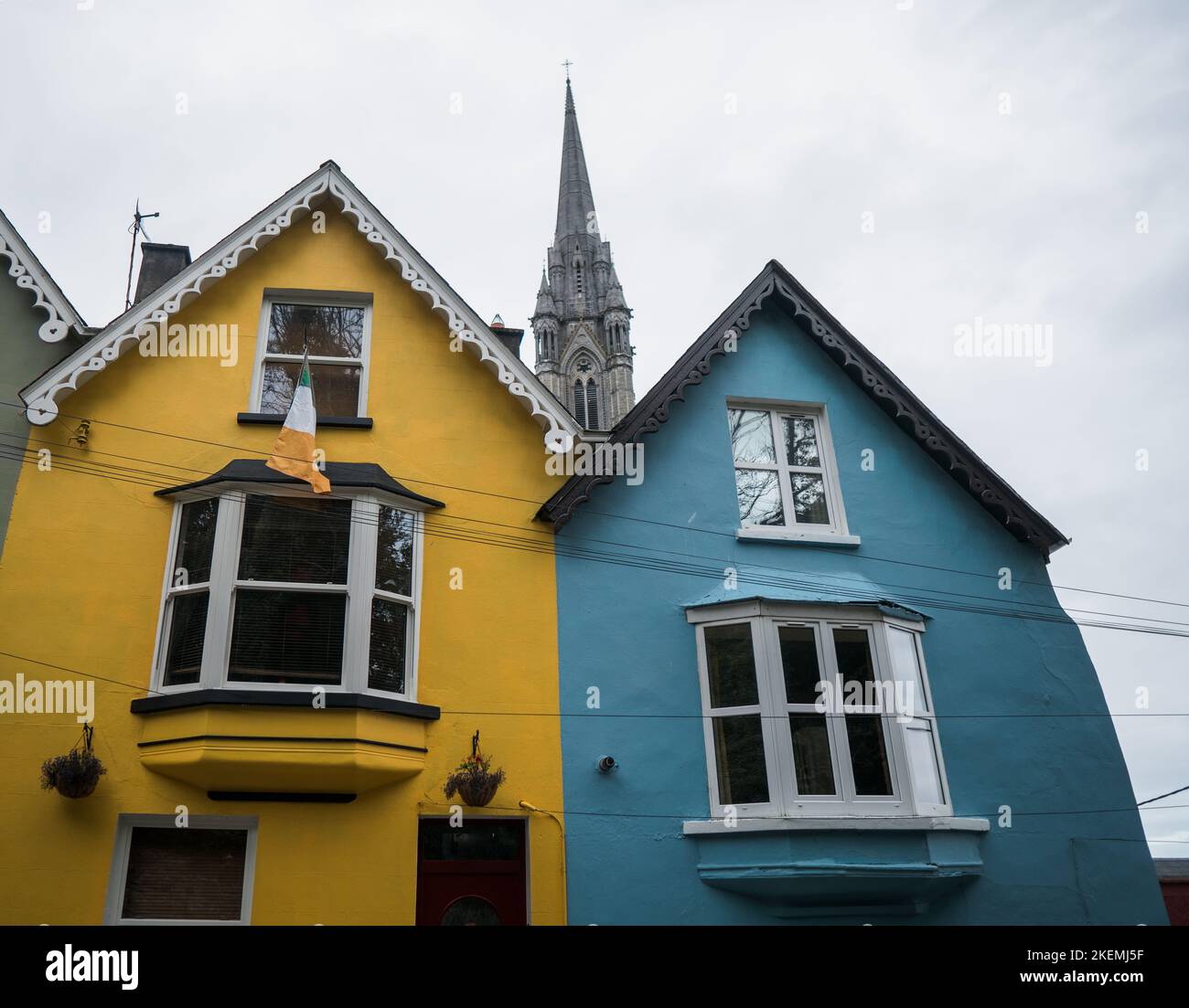 Colorful row of houses with towering cathedral in background in the ...