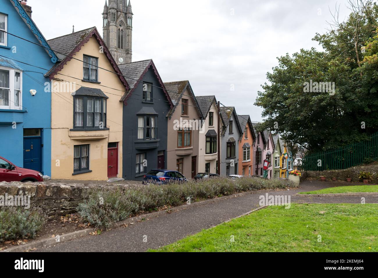 Colorful row of houses with towering cathedral in background in the ...