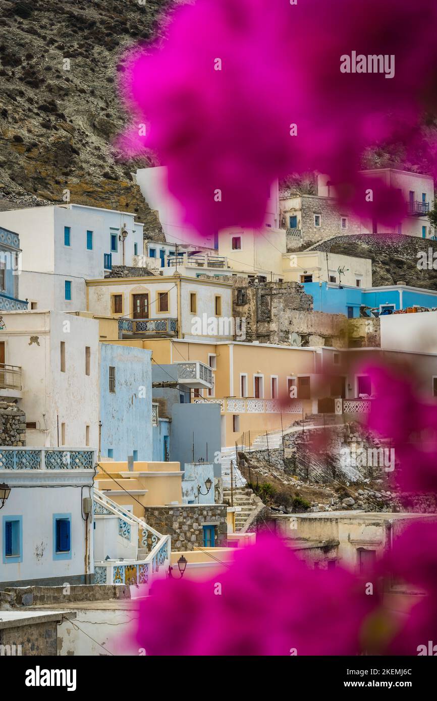 A vertical shot of colorful houses on Karpathos Island and purple ...