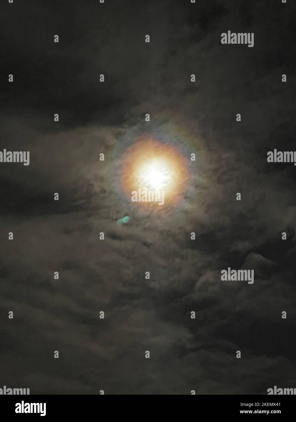 Rainbow Moon haze halo in cloudy night sky Stock Photo - Alamy
