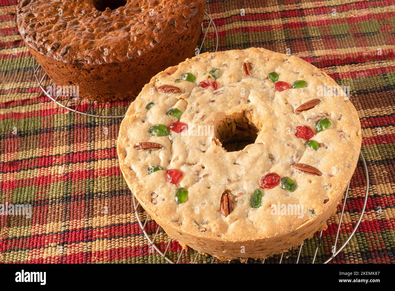Homemade dark and light fruitcakes fresh out of the oven and cooling on ...