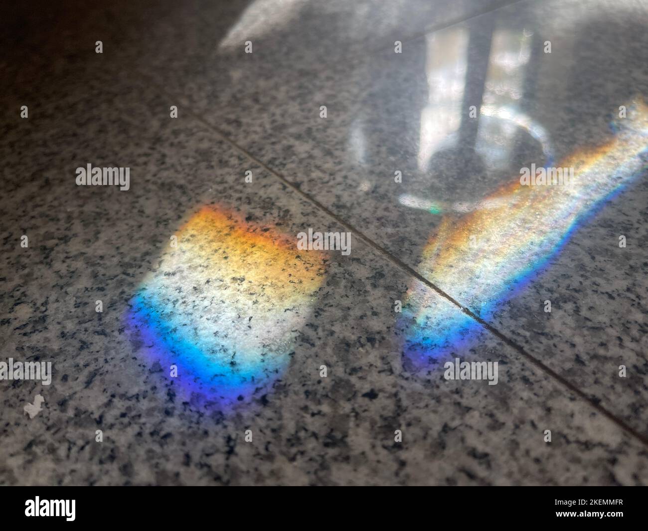 Rainbow sunlight refraction on grey granite floor Stock Photo - Alamy