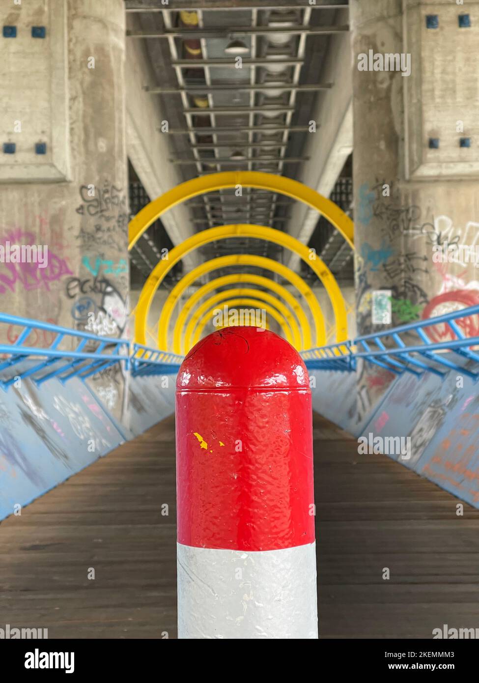 Vertical shot of a red metal pole in front of futuristic industrial ...