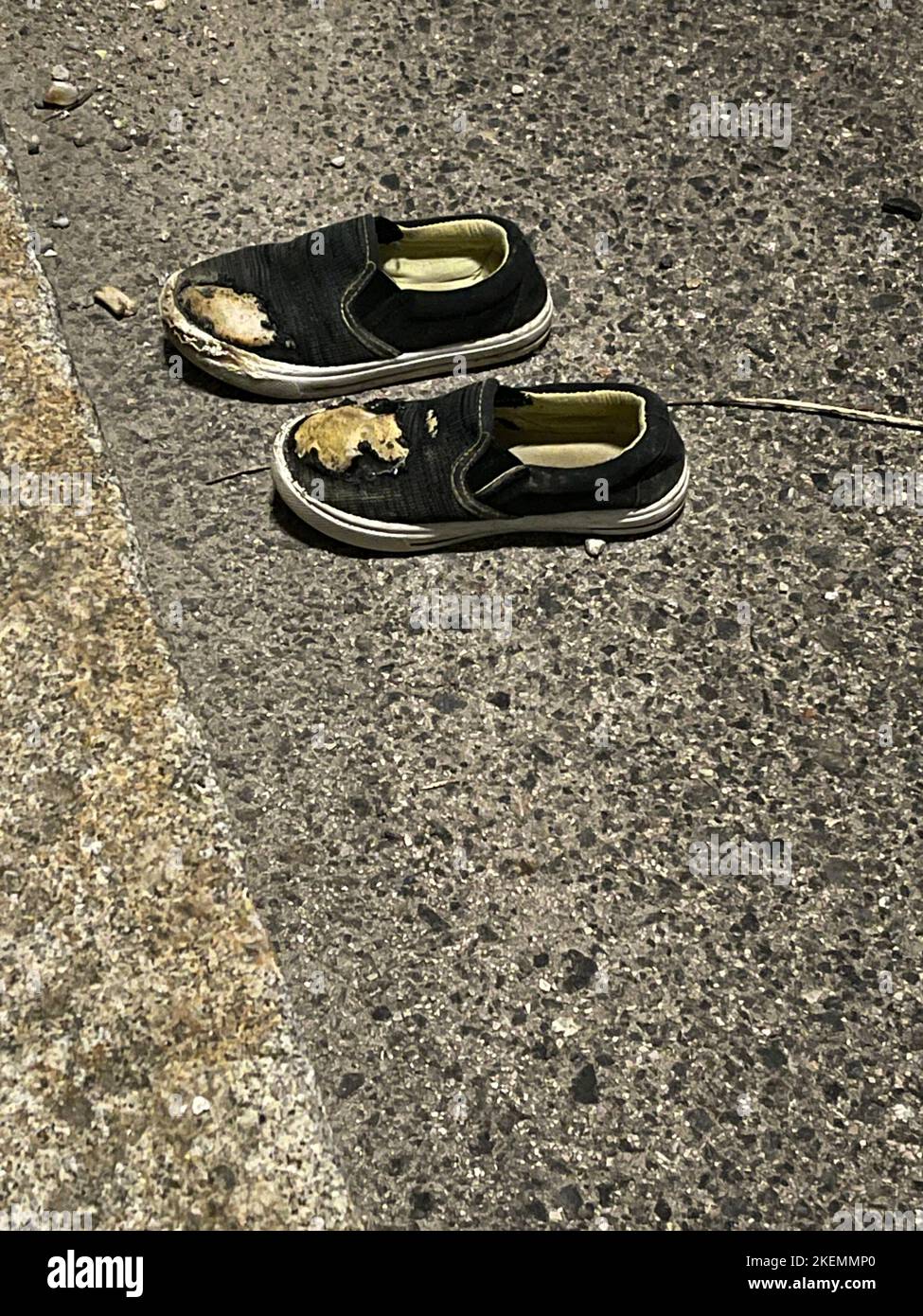 Vertical shot of damaged child's shoes abandoned on the road Stock ...