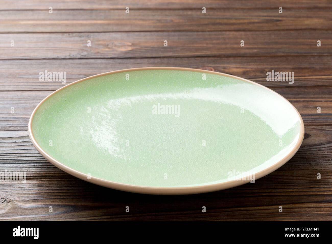 Perspective view of empty green plate on cement background. Empty space ...