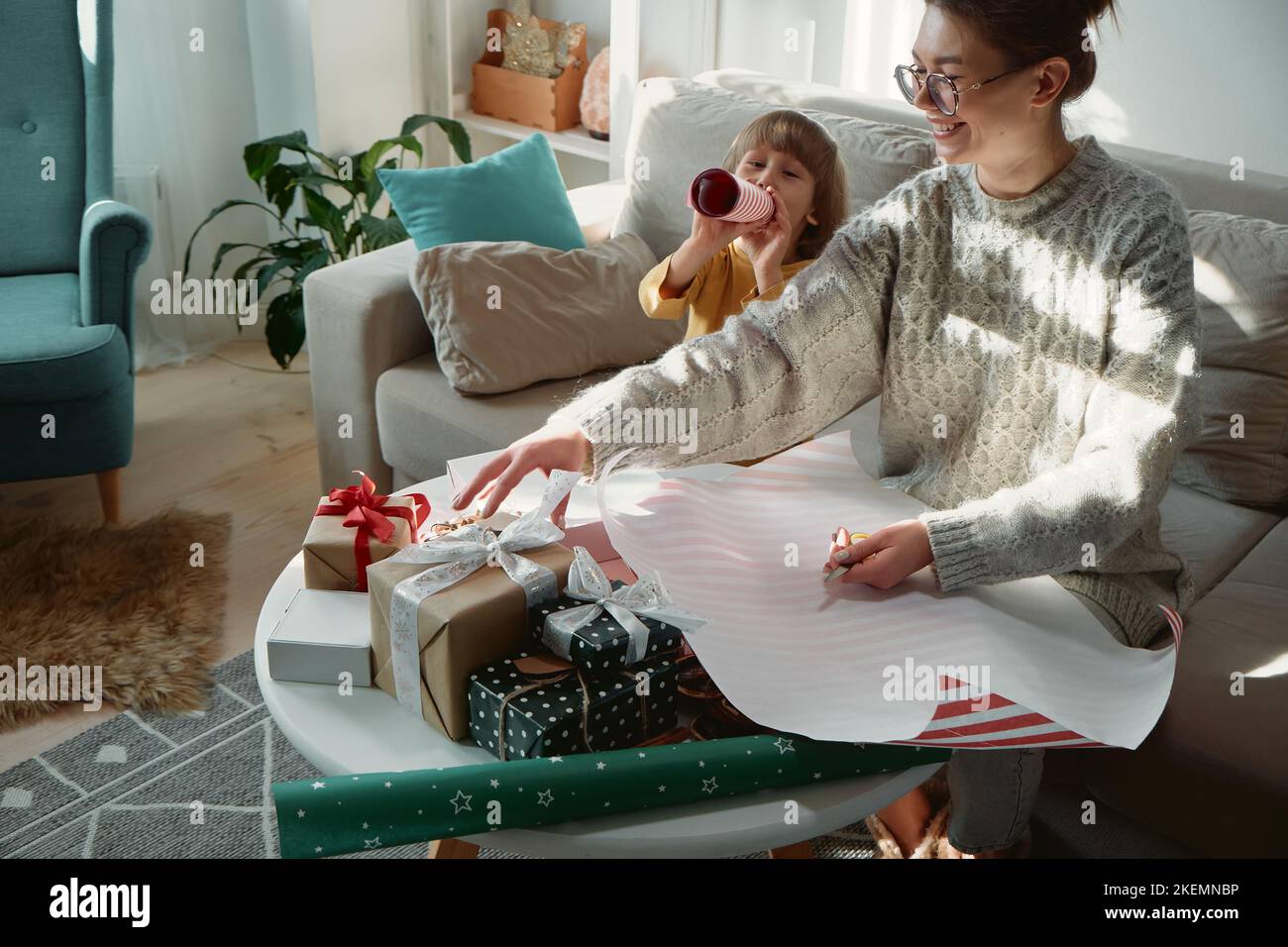 Decorating Christmas gifts, family mother and child wrapping Christmas ...