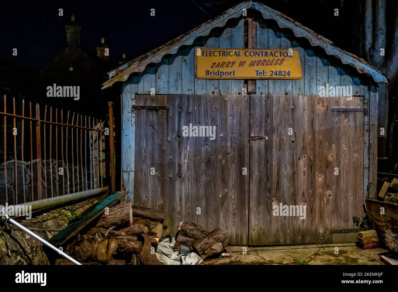 Bridport at night. Wooden shed housing an electrical contractor in a ...