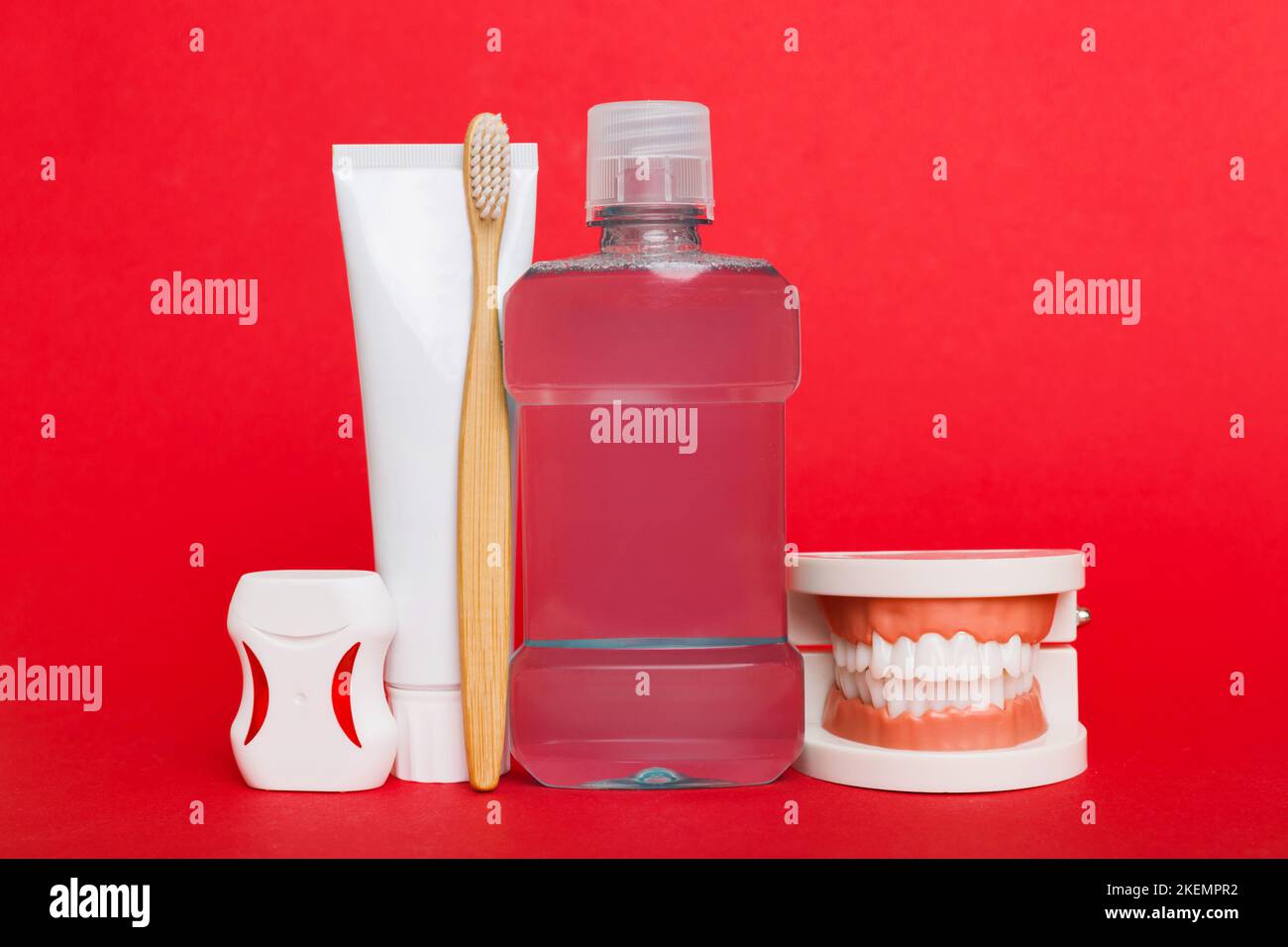 Mouthwash and other oral hygiene products on colored table top view ...