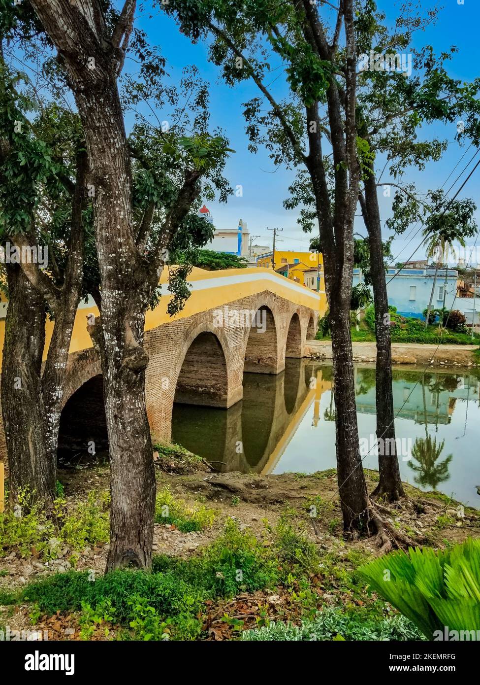 A vertical shot of an arched bridge over the river Stock Photo - Alamy