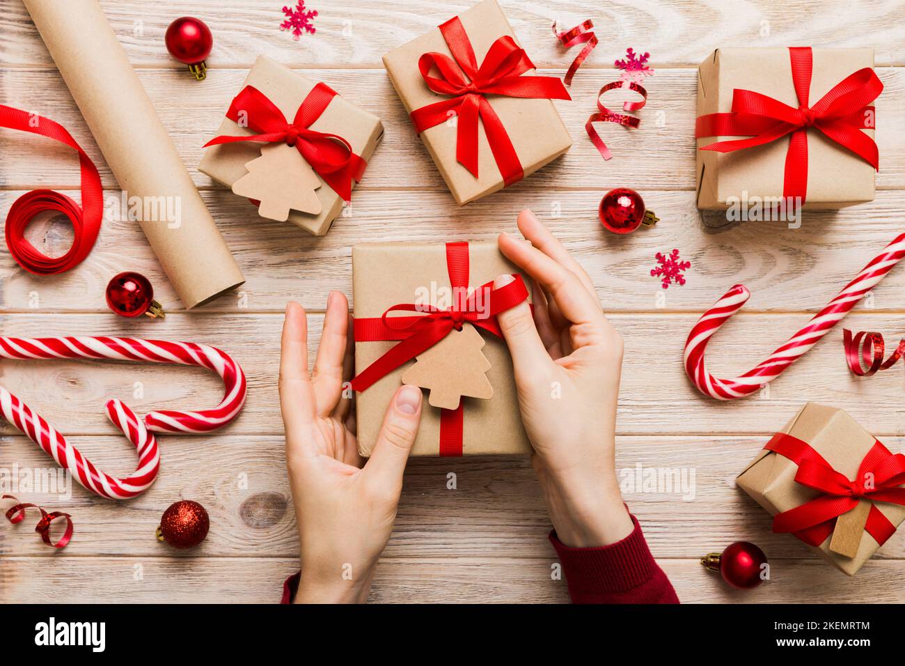 Woman hands holding gift box, preparing surprise for holiday, top view ...