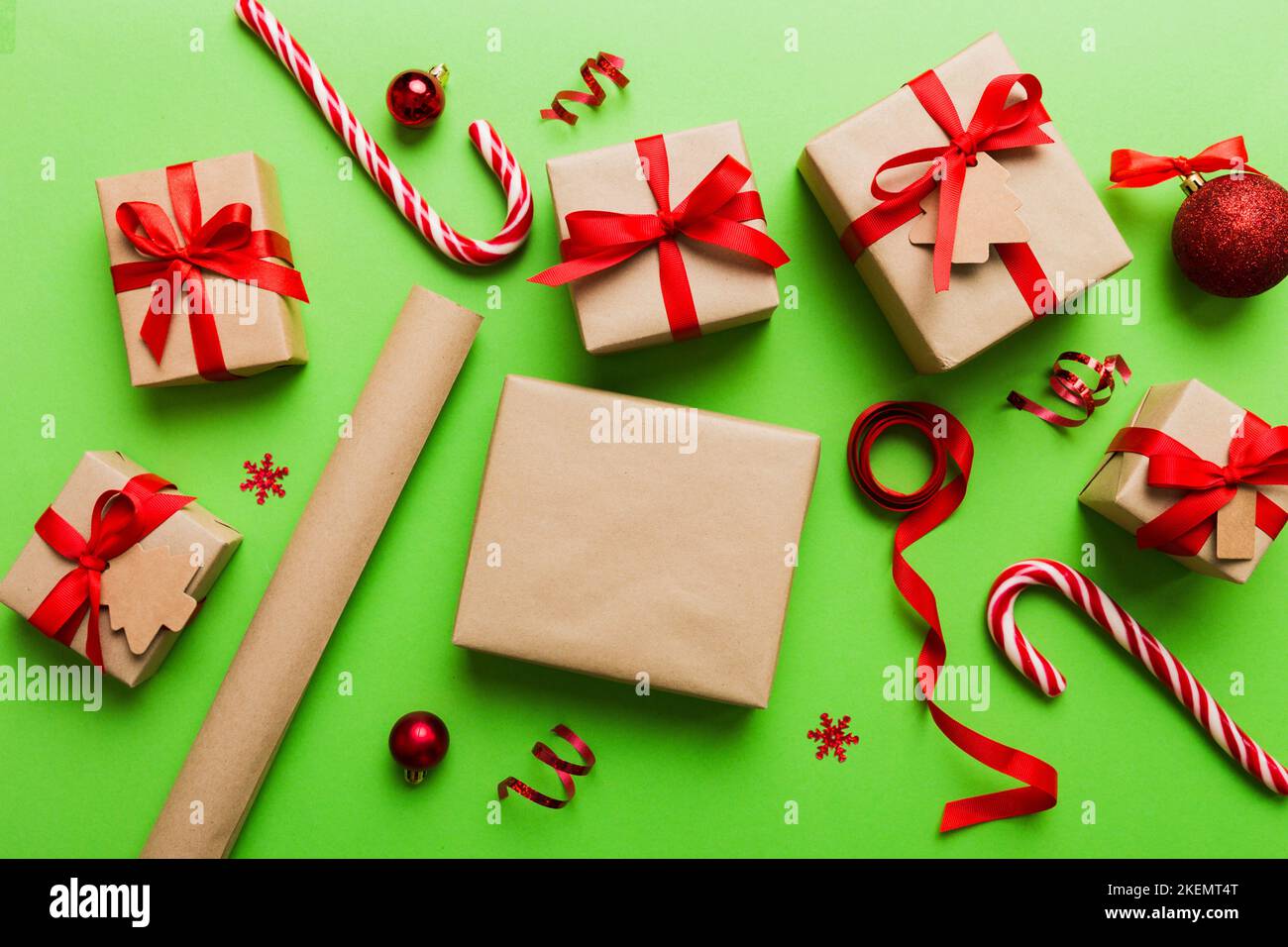 Christmas kraft gifts box with ribbon on colored background. Cozy ...