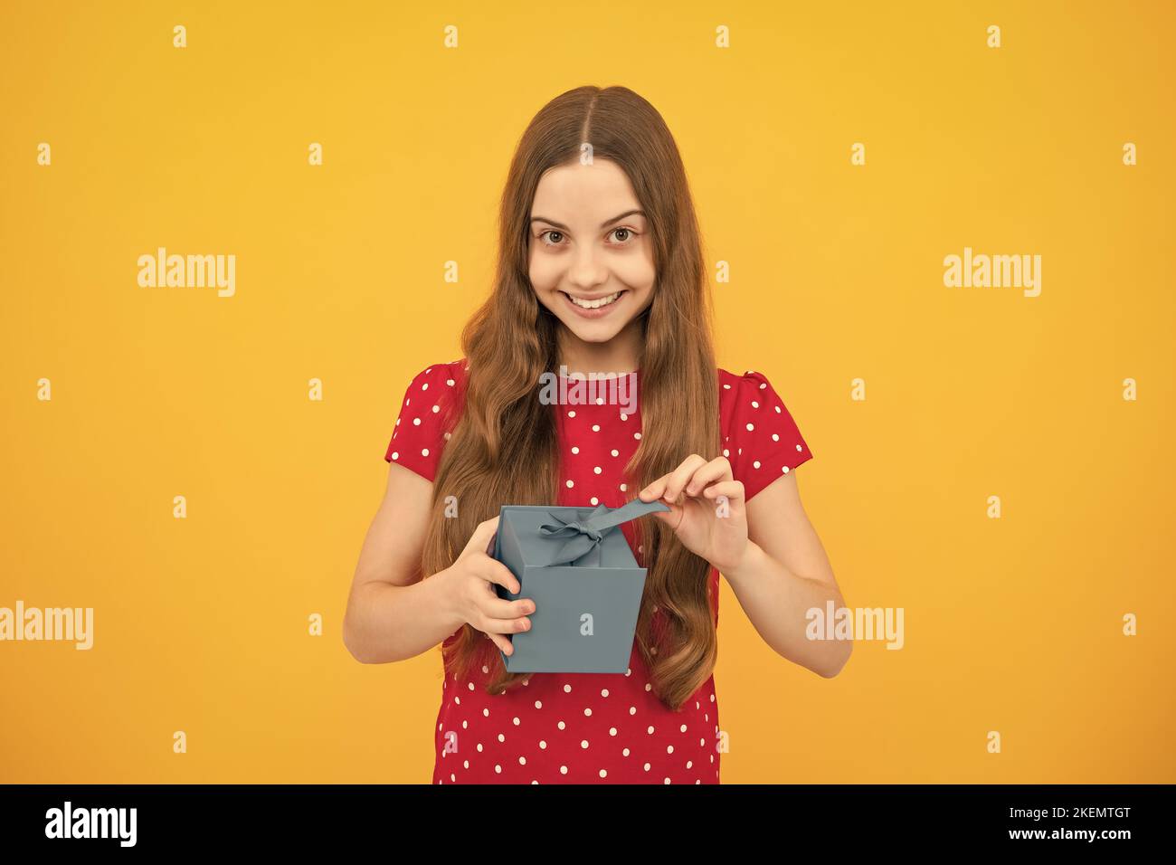 Emotional teenager child hold gift on birthday. Funny kid girl holding ...