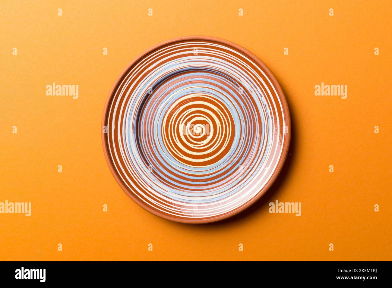 Top view of isolated of colored background empty round brown plate for ...