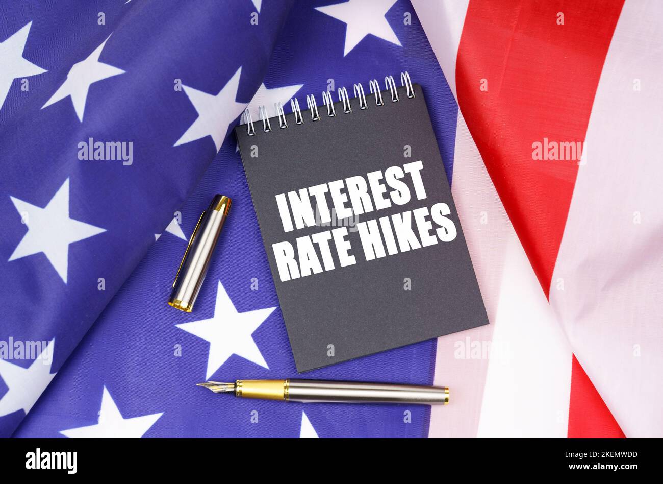 Business concept. On the American flag lies a pen and a notebook with ...