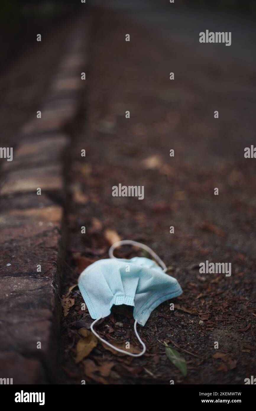 An old face mask on the stret ground, closeup shot Stock Photo - Alamy