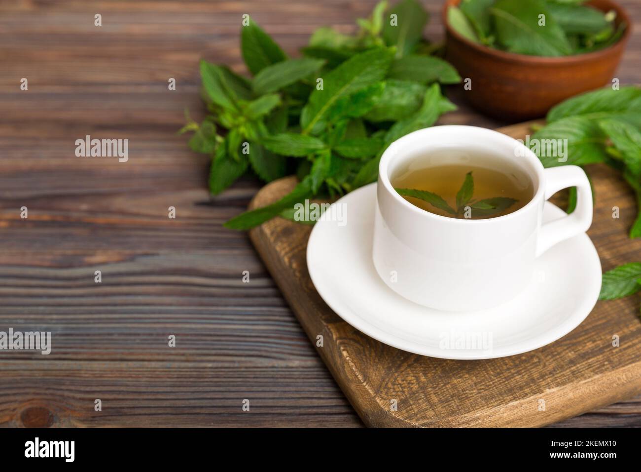 Cup of mint tea on table background. Green tea with fresh mint top view ...