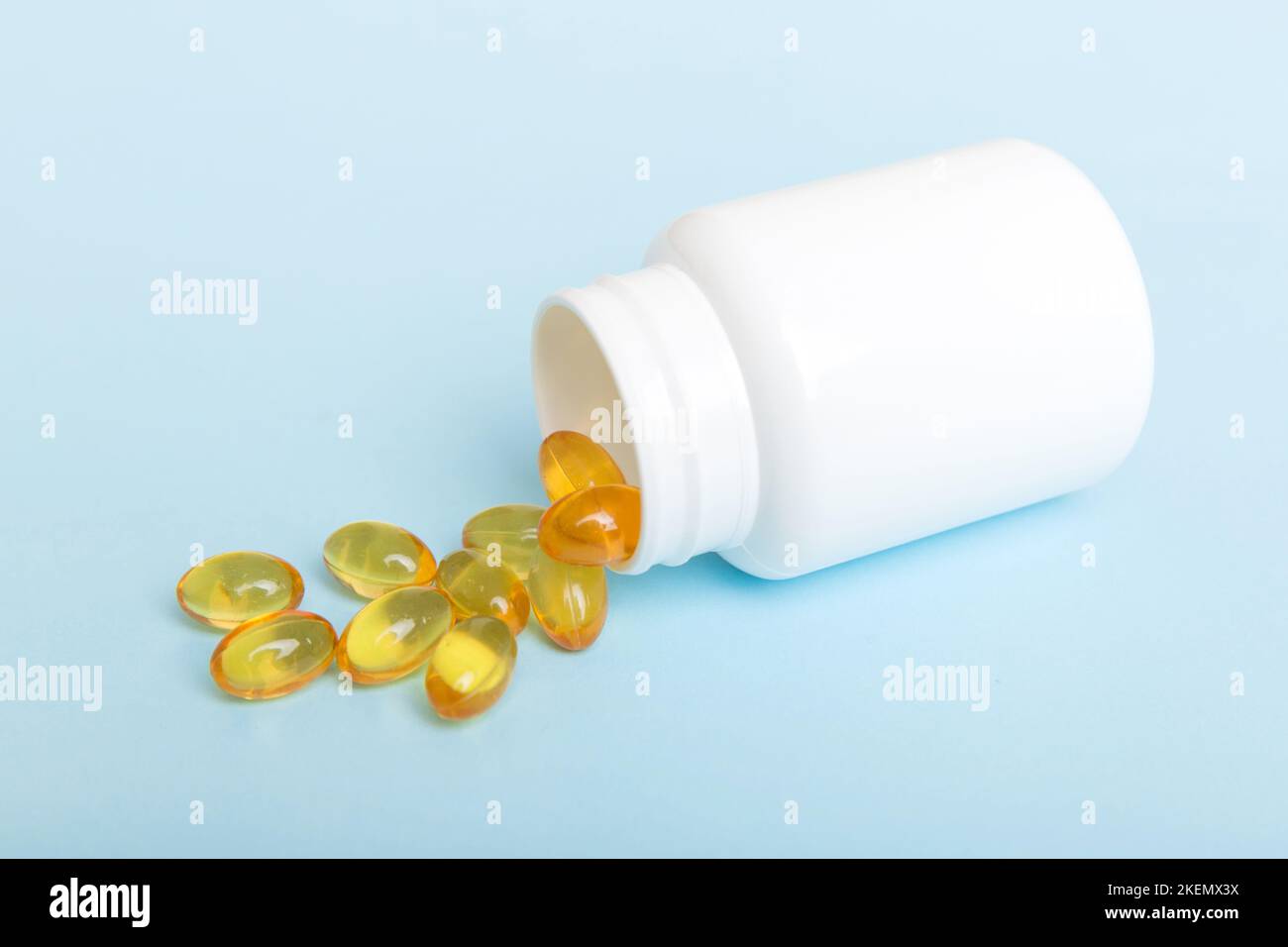 Fish oil capsules blue table hi-res stock photography and images - Alamy