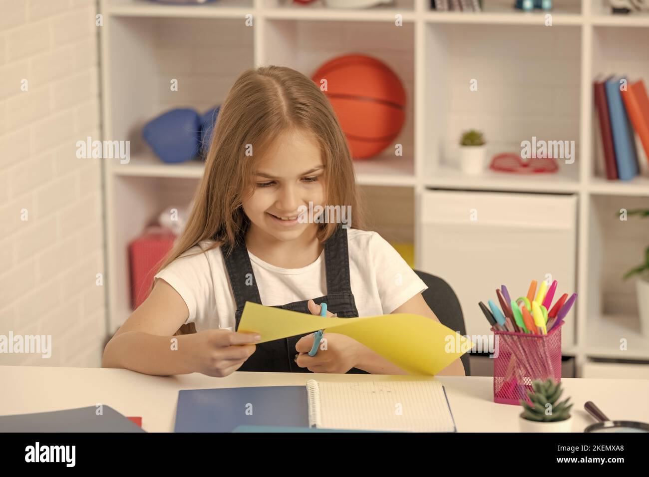 happy child cut paper in school classroom Stock Photo - Alamy