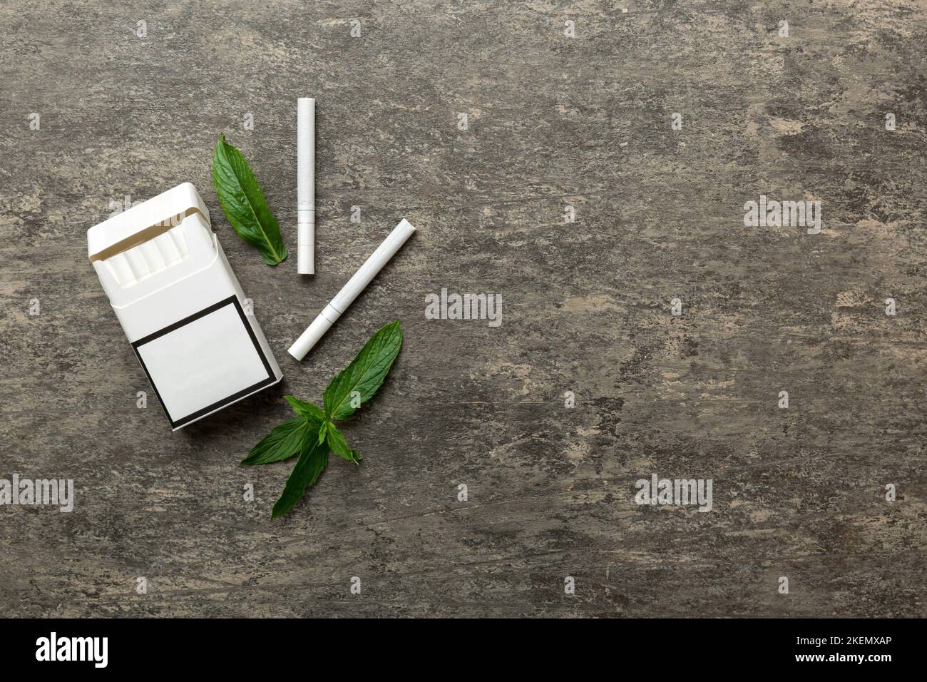 Pack of menthol cigarettes and fresh mint on colored table, Menthol ...