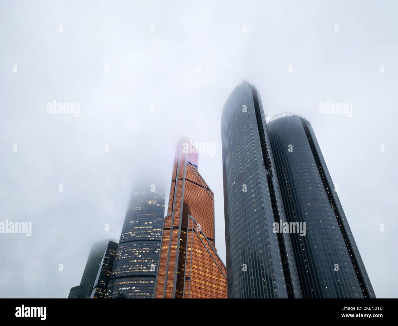 Tops of modern corporate buildings against the foggy sky. high-rise ...