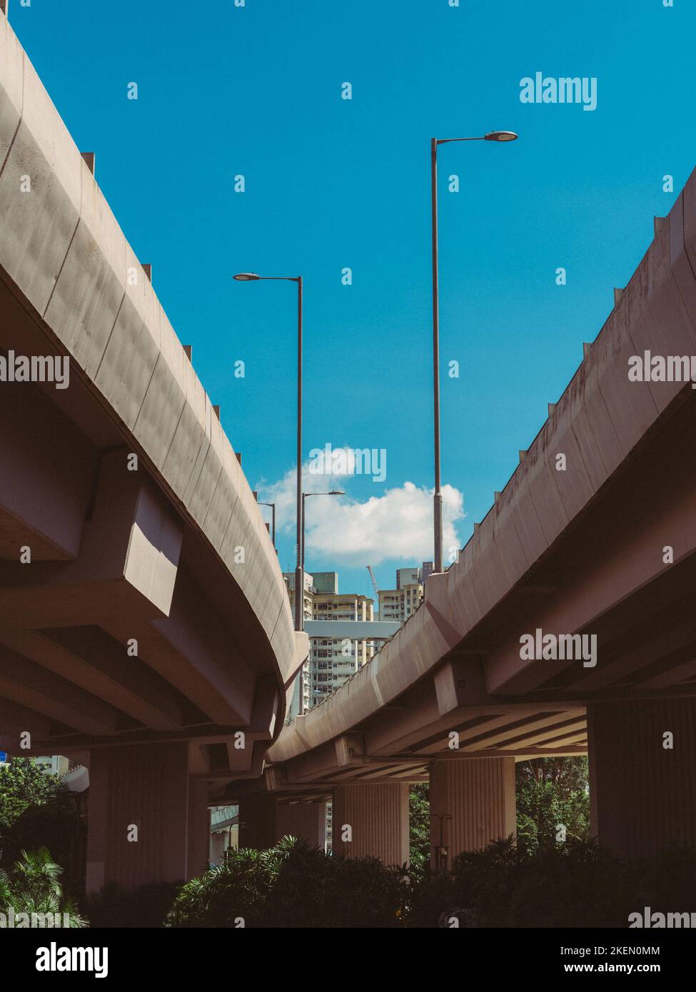 A vertical shot from under bridges with urban city buildings in the ...