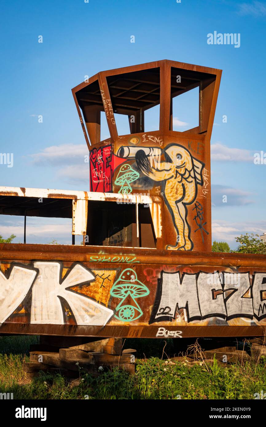 Graffiti: a drinking fish painted on the wreck of an old rusty ship ...