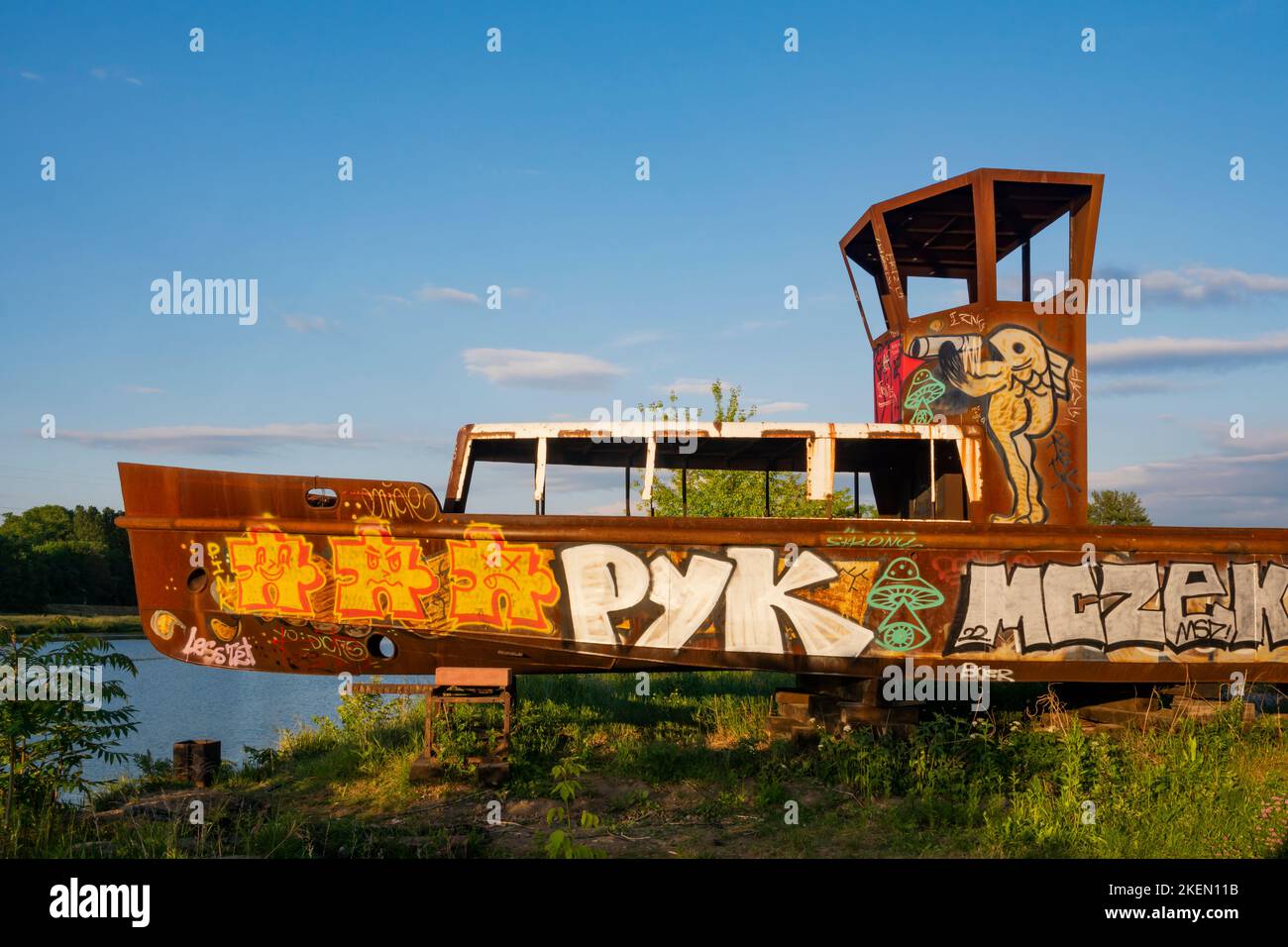 Graffiti: a drinking fish painted on the wreck of an old rusty ship ...