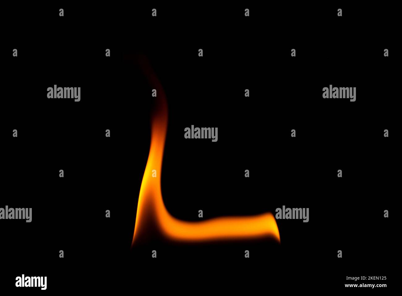 An orange flame on black background Stock Photo - Alamy