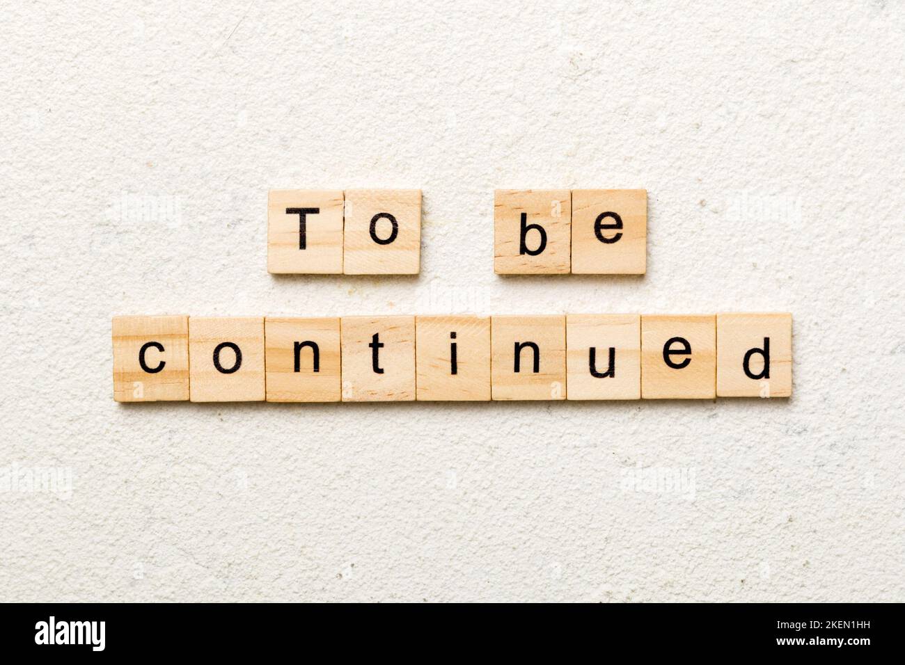 To be continued word written on wood block. To be continued text on ...