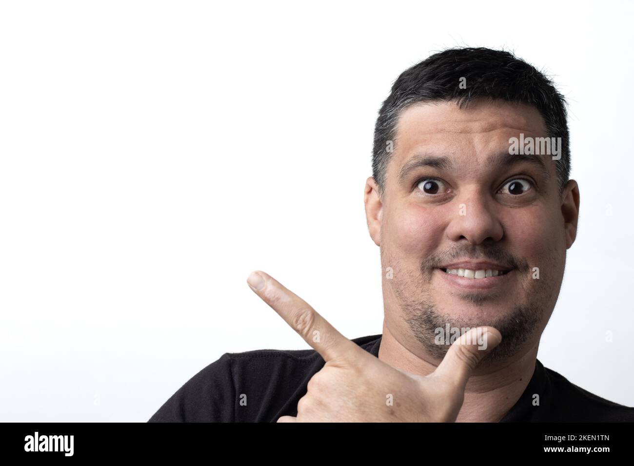 man pointing with his index finger cheerfully upwards, on a white ...