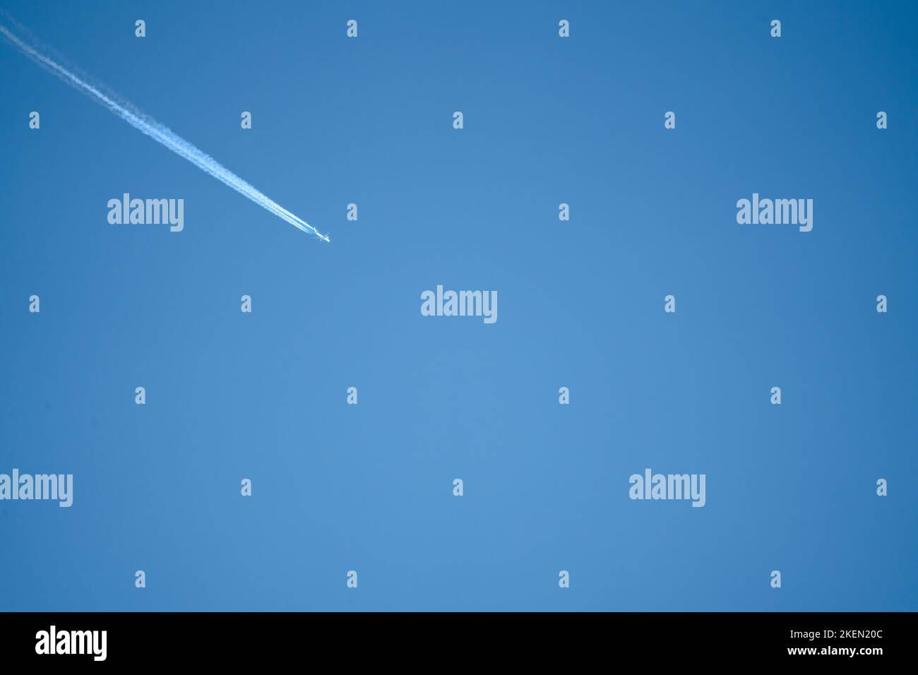 high altitude twin engine contrails (jet airplane vapour trails) across ...