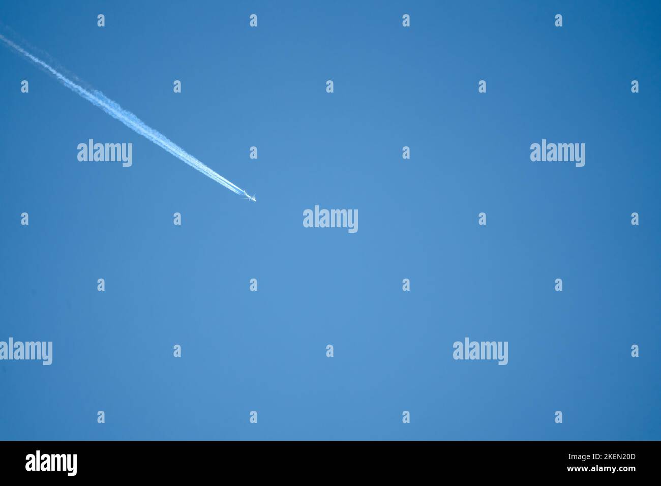 high altitude twin engine contrails (jet airplane vapour trails) across ...