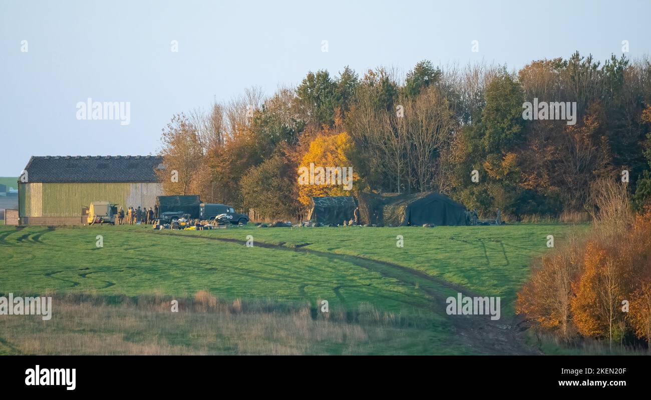 British army soldiers camped on the edge of woodland preparing for a ...