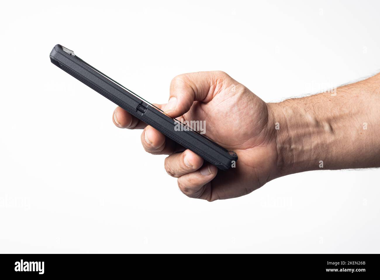 Hand and arm of a man holding a cell phone with a blank screen on a ...