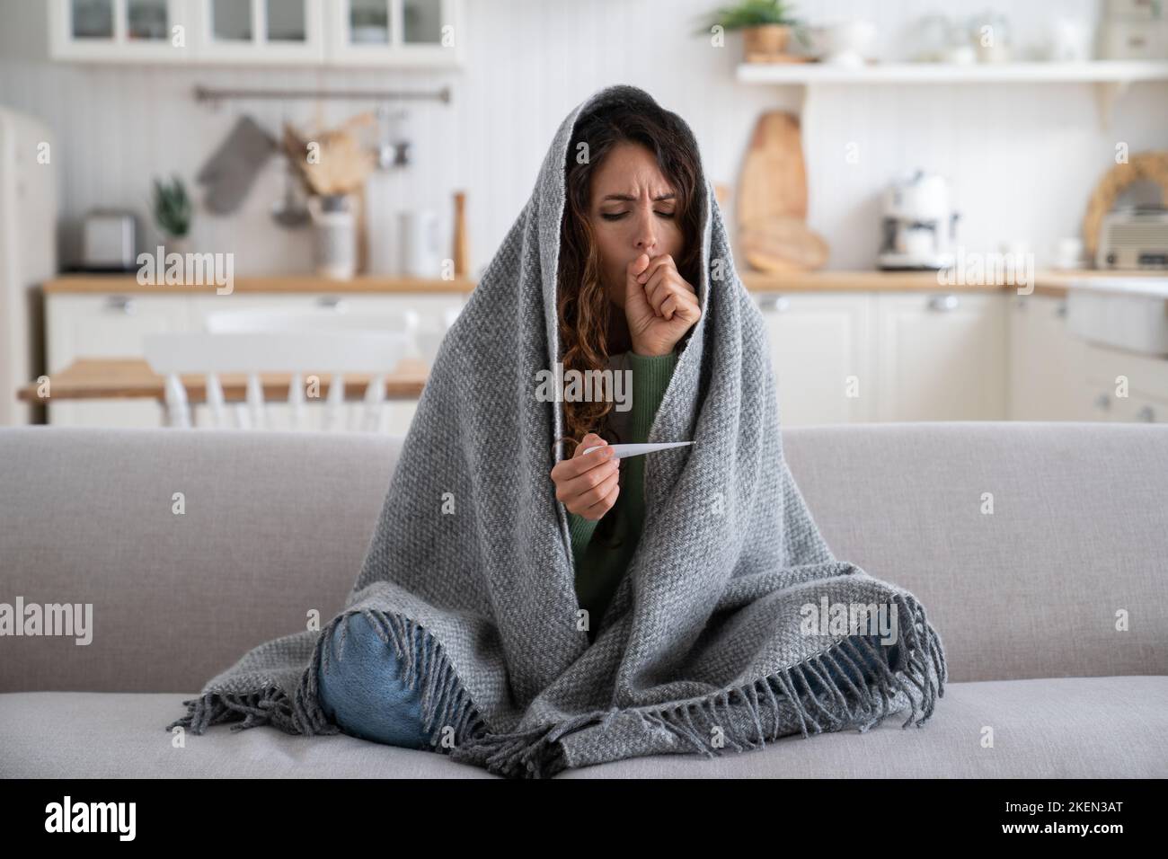 Sick at home. Unhealthy, young woman coughing while measuring body ...