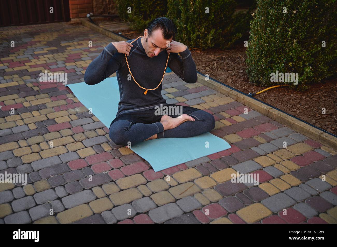 Portrait of a yogi, sitting on a mat during yoga practice. Healthy and ...