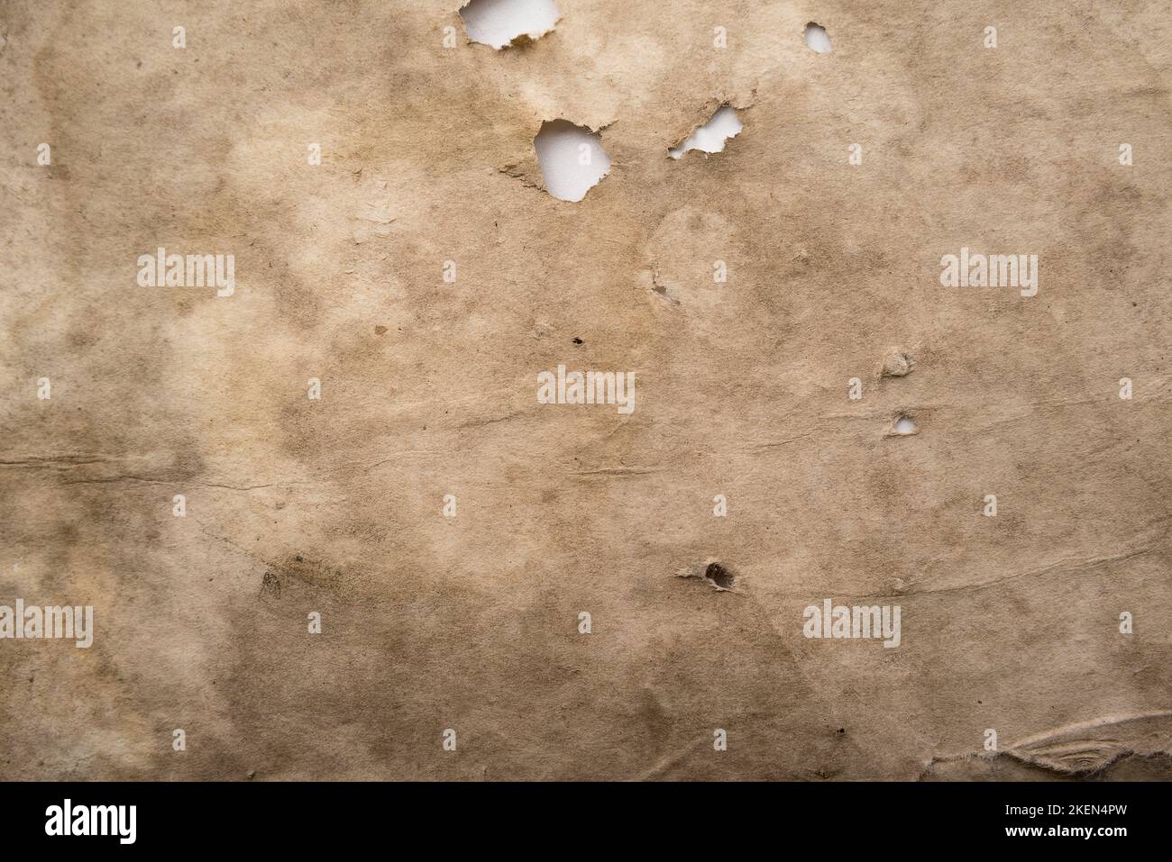 Brown old vintage grungy paper with holes Stock Photo - Alamy