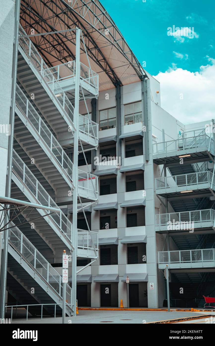 A vertical low angle shot of a modern building with a fire escape ...