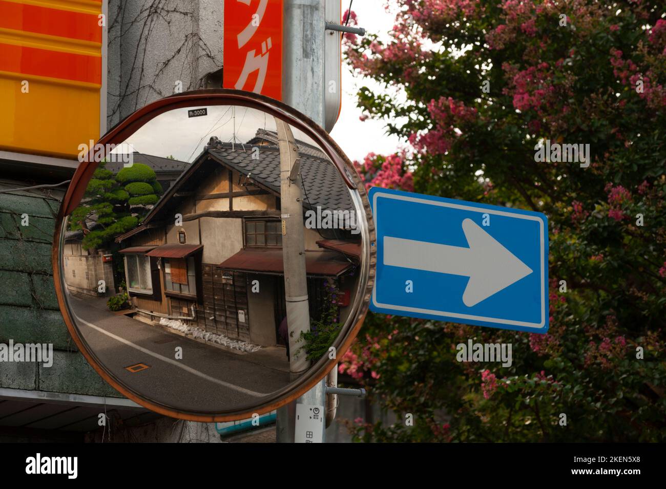 A convex mirror on a narrow street in Matsumoto gives drivers the ...