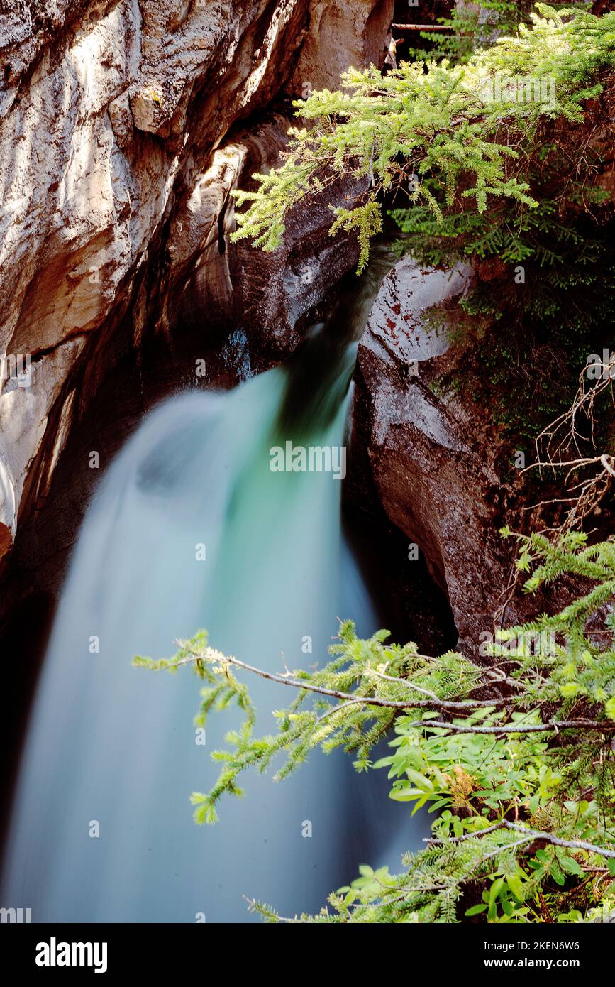 A vertical shot of a waterfall on wet rocks Stock Photo - Alamy