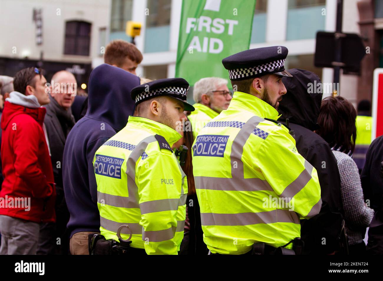 Two police officers in yellow uniforms on patrol in London, United ...