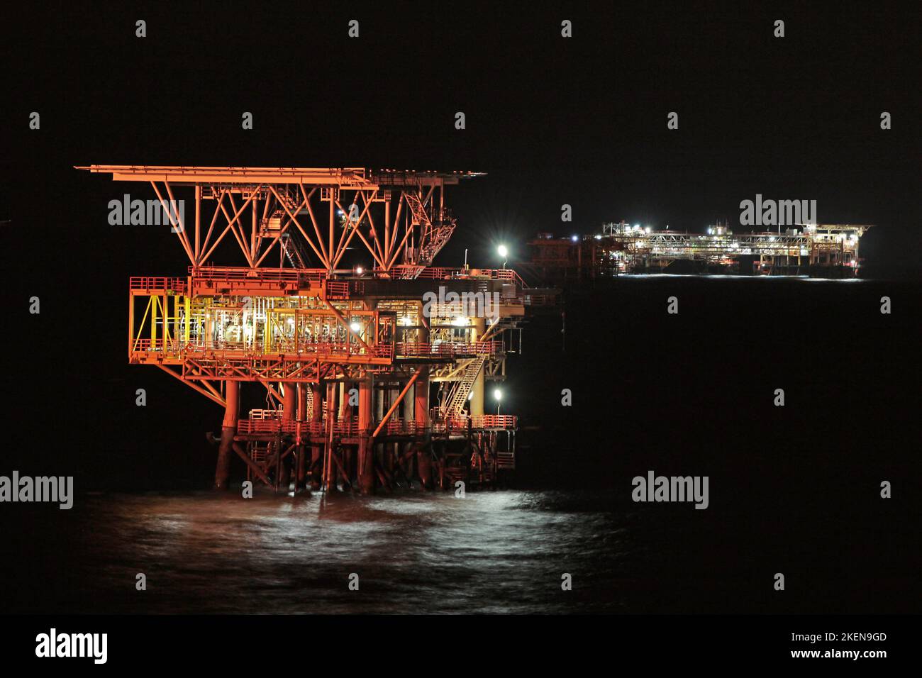 Silhouette of an offshore oil rig at night in the South China Sea Stock ...