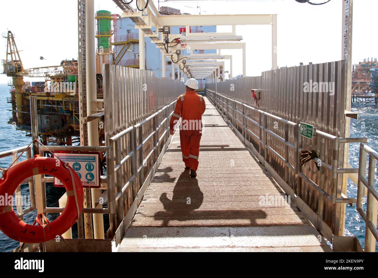 Rig worker and an offshore oil rig Stock Photo - Alamy