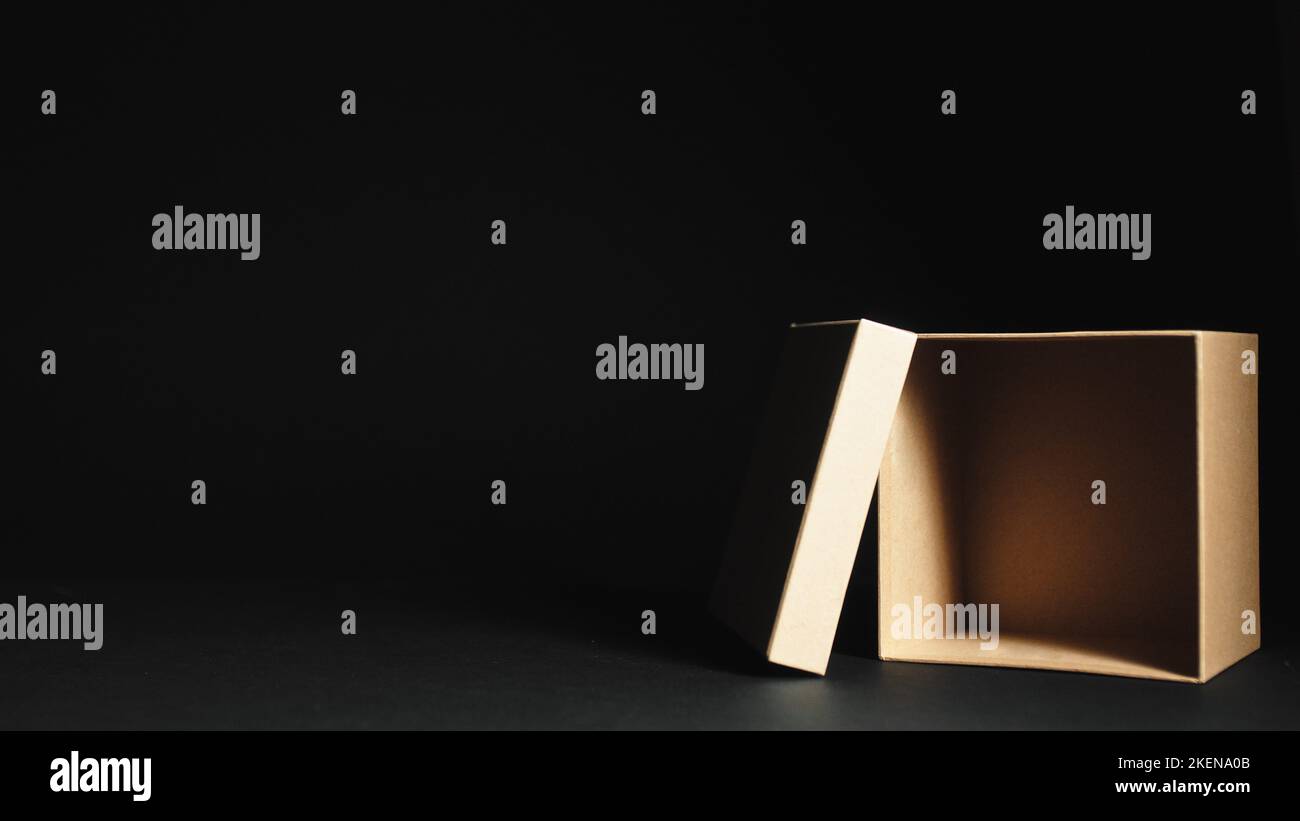 Cardboard box on black background Stock Photo - Alamy