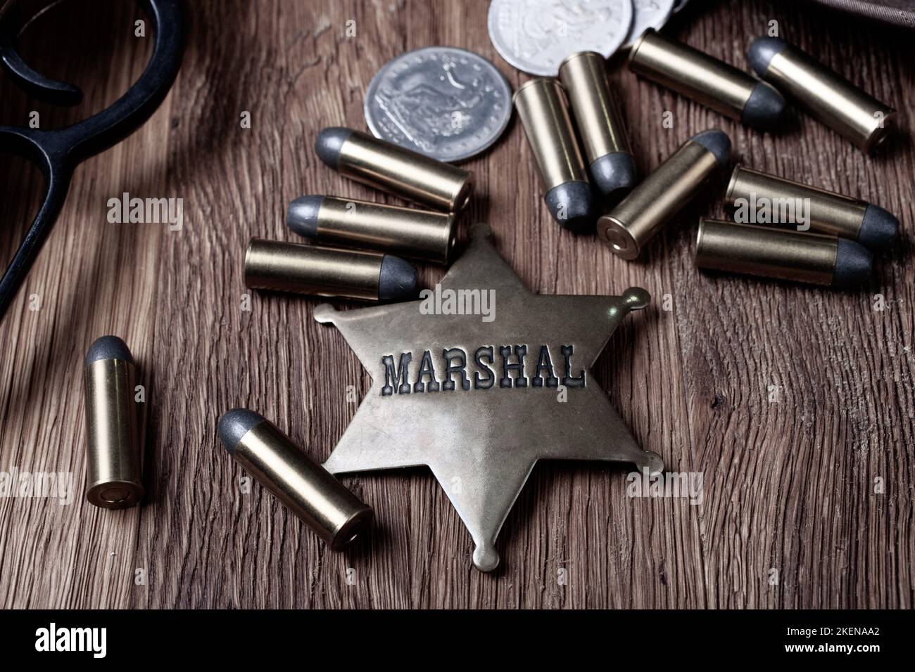 Old west marshal badge with rifle, silver dollar coin and ammunition on ...