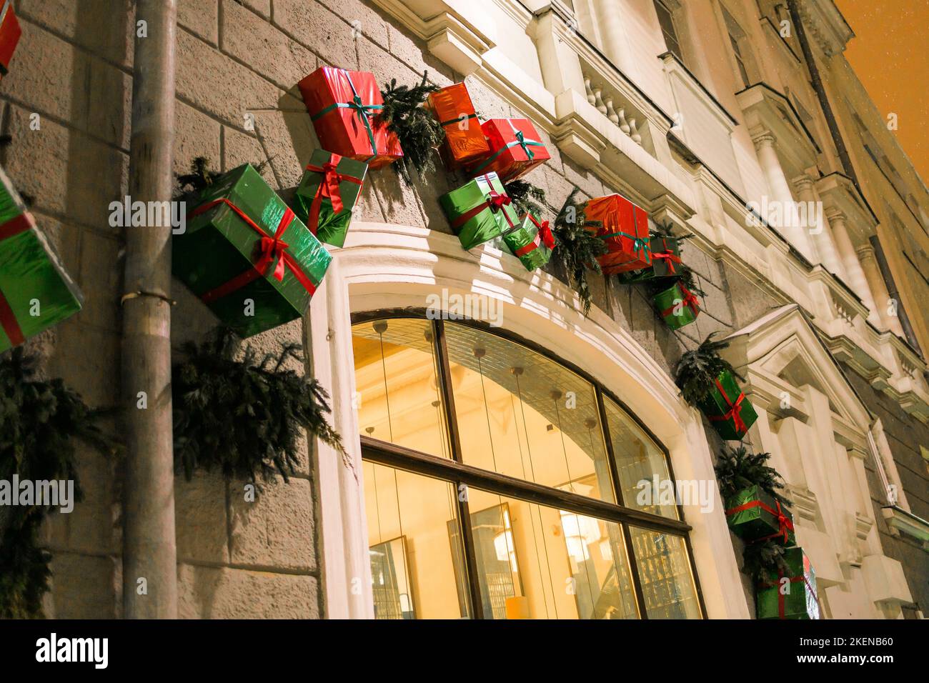 Stylish christmas fir branches with baubles and gift boxes on front of ...