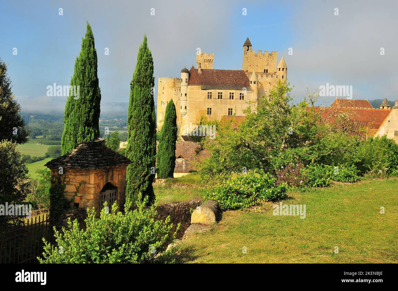 A beautiful view of the Beynac Castle surrounded by greenery in France ...
