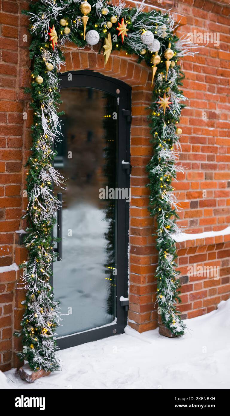 Stylish christmas fir branches with baubles and sparkling garland on ...