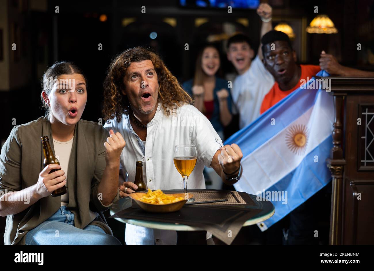 Joyful fans of the Argentina team celebrating the victory in night bar ...